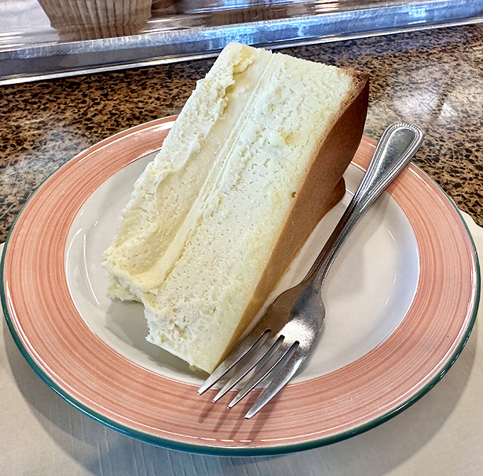 Cheesecake so pristine it belongs in the Louvre—dense, velvety perfection that makes you question why people bother with fancy desserts.