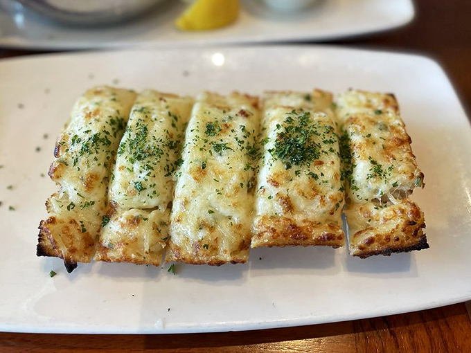 Cheesy garlic bread that should come with a warning label: "May cause spontaneous expressions of joy and/or stretchy pants regret."