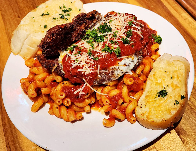 Chicken parmesan that doesn't just sit on pasta&mdash;it lounges regally, like Italian royalty holding court over perfectly sauced macaroni and garlic bread courtiers.