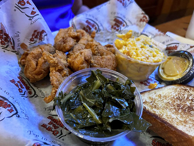 Crispy chicken tenders nestled beside collard greens and cornbread. Southern hospitality on a plate, no introduction necessary.