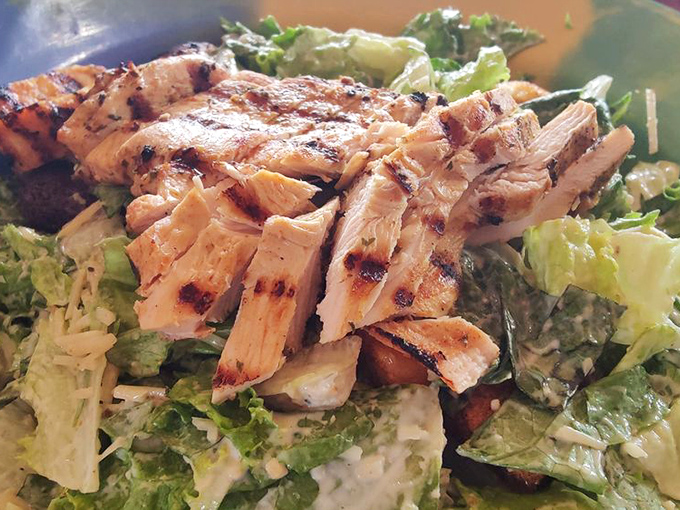 Fresh Caesar salad that reminds you even dive bars can handle greens with surprising finesse and flair.