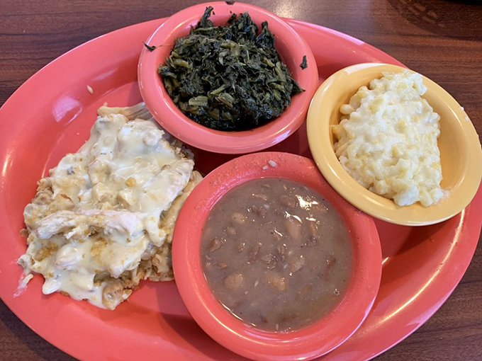 Southern comfort on a plate: chicken casserole, turnip greens, mac and cheese, and beans. Like a warm hug from someone who truly understands comfort food.