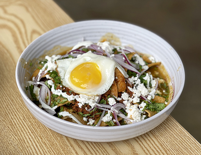 Chilaquiles crowned with a perfect egg &ndash; the breakfast royalty you didn't know you needed in your life. That queso fresco is doing the Lord's work.