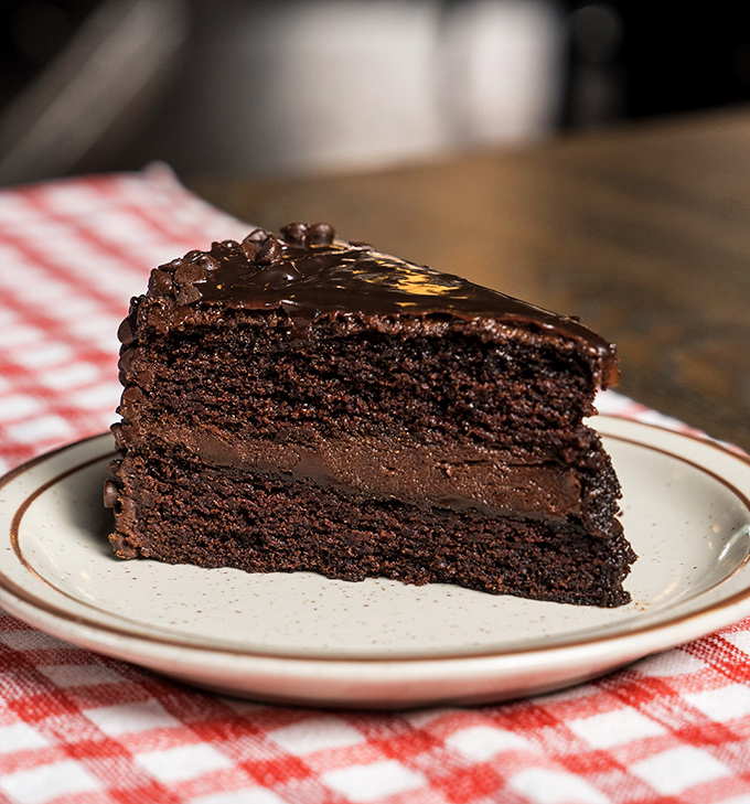 This chocolate cake doesn't need fancy garnishes &ndash; three layers of cocoa commitment that would make Willy Wonka reconsider his life choices.