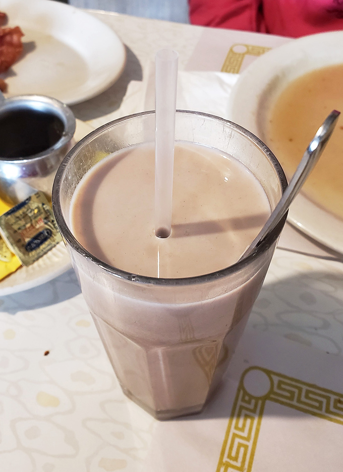 Chocolate milk in a proper glass&mdash;because sometimes adulting is overrated and the simple pleasures still hit different when you're hungry.