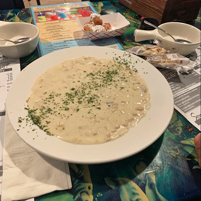 A bowl of creamy clam chowder that could make a New Englander question their loyalty &ndash; notice the corn fritters standing by for inevitable dunking.