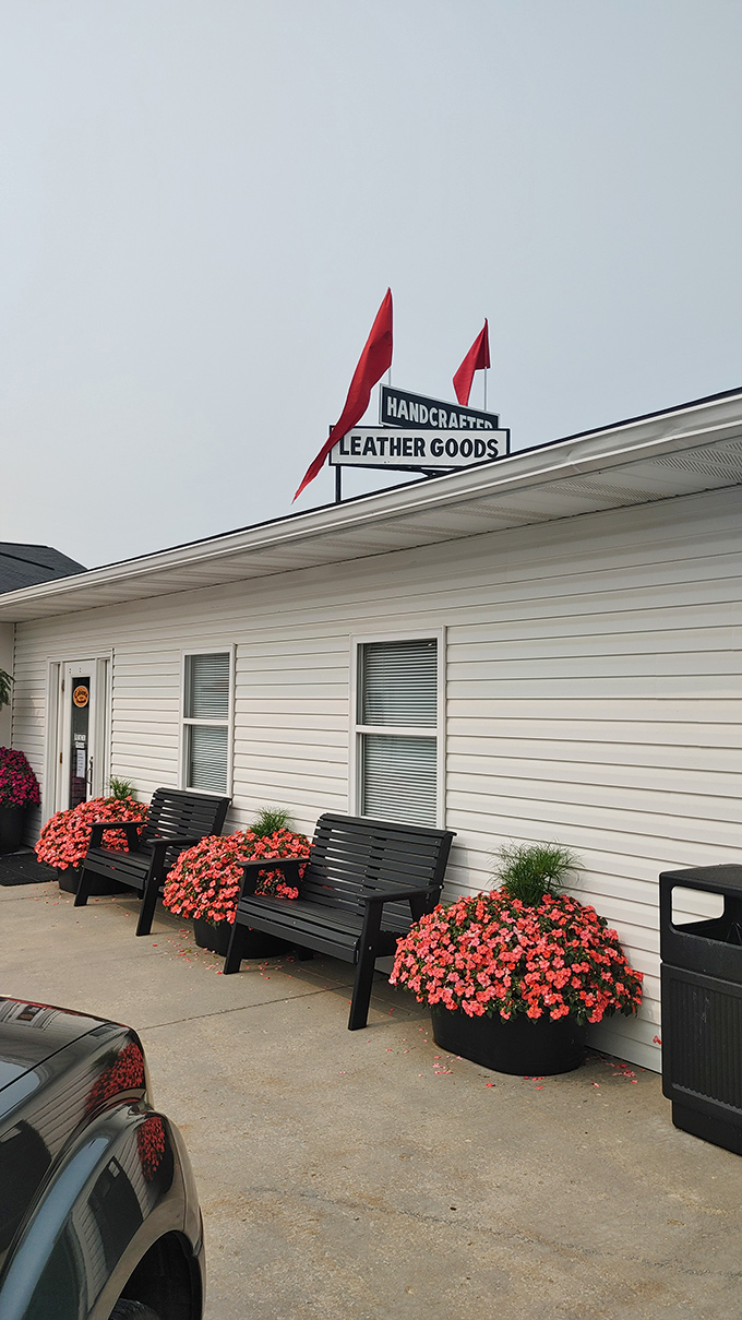 Handcrafted leather goods find their home amid coral blooms, proving Amish craftsmanship extends well beyond the dining table.