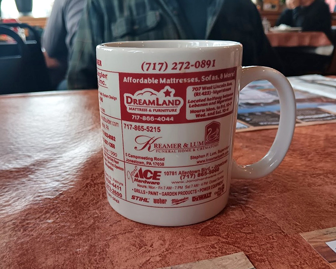 Even the coffee mugs tell stories here. This isn't just a vessel for caffeine—it's a community bulletin board for your hands.