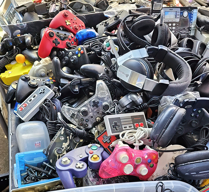 The video game controller graveyard, where forgotten Nintendo, Xbox, and PlayStation peripherals wait for nostalgic gamers to resurrect them.