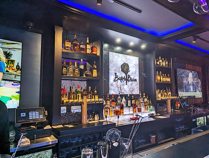 Behind this bar, bottles aren't just inventory&mdash;they're promises. The Bake'n Bacon logo glows like a beacon for the flavor-famished.