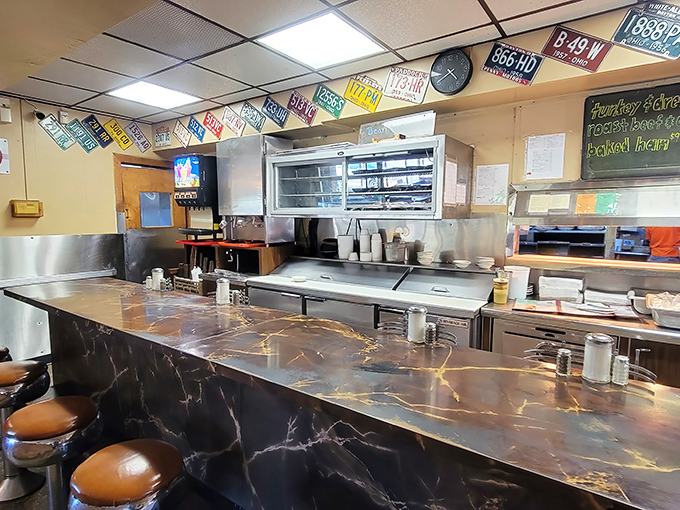 The counter where breakfast dreams come true, complete with vintage Coca-Cola signage and the kind of stools that have witnessed countless life stories.