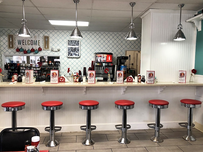 Classic counter seating with retro red stools—where solo diners become regulars and servers remember your coffee preferences after just one visit.