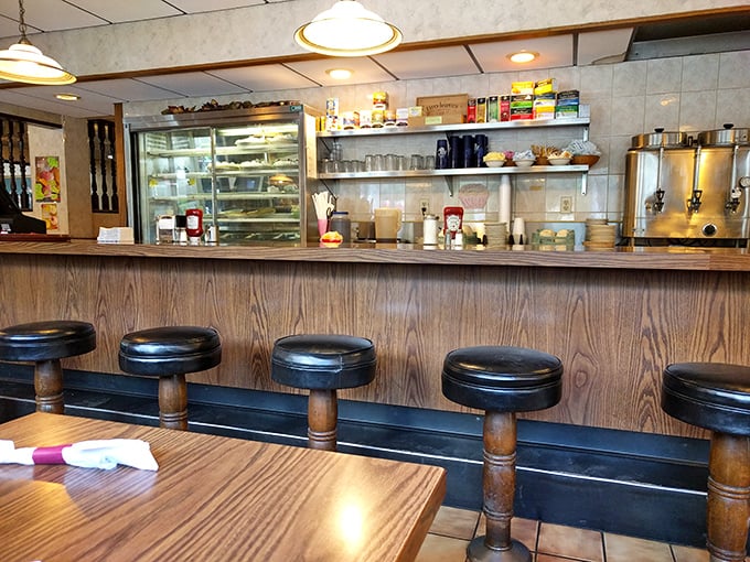 Counter seating where regulars perch like sentinels of tradition, watching their breakfast being crafted with practiced precision.