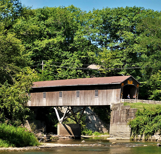 This weathered covered bridge spans not just water but time itself, connecting modern visitors to Conneaut's rich historical past.