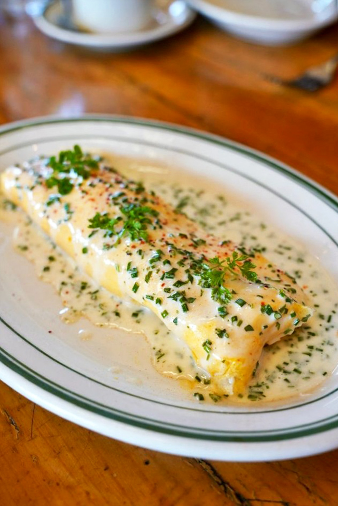 When fish meets breakfast magic&mdash;this delicate white fish bathed in herb-flecked cream sauce is morning decadence at its finest.