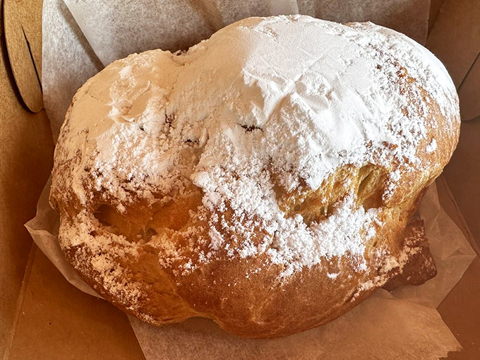 This cream puff isn't just dusted with powdered sugar&mdash;it's wearing a snow-capped mountain of it. Inhaling before biting is not recommended.