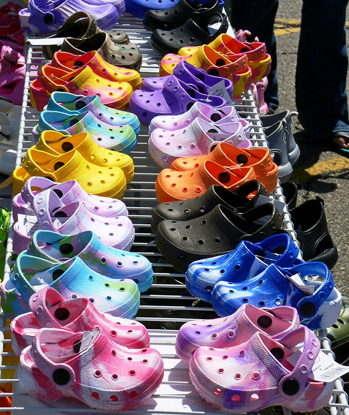 A rainbow coalition of Crocs stands at attention, proving that comfort has finally made peace with color theory.
