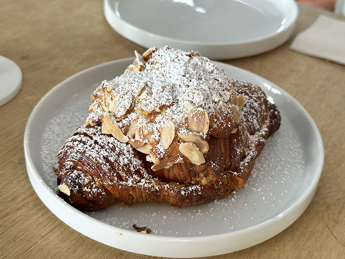 A croissant sandwich that's dressed for success &ndash; golden, flaky exterior cradling eggs and meat like they've finally found their forever home.