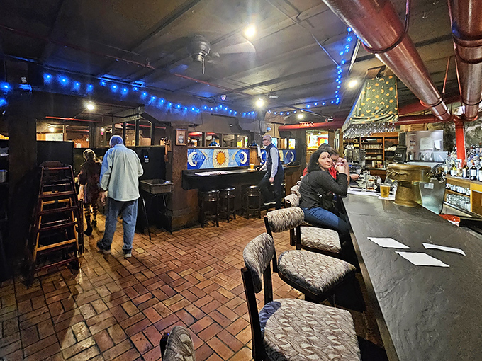 The bar area buzzes with the energy of people who know they're about to eat well, with blue lights adding a touch of speakeasy charm.