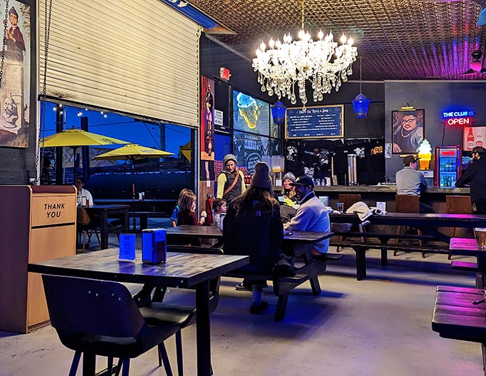 Evening at Grand Ole BBQ&mdash;where chandeliers meet picnic tables and the neon glow promises good times and full bellies ahead.