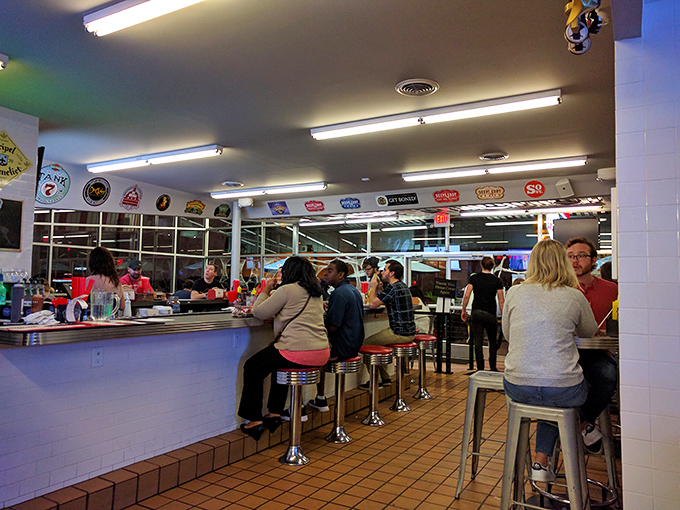 The counter seating isn't just nostalgic—it's front-row tickets to the dinner show, where burgers are the headlining act and milkshakes are the opening band.