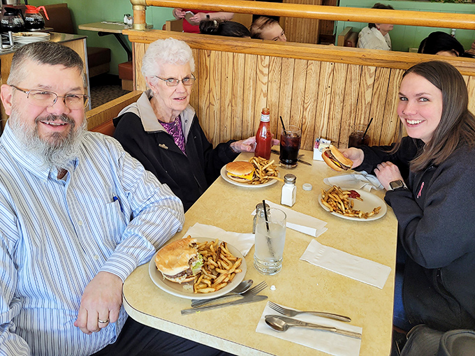 Three generations sharing burgers and fries&mdash;the universal language of "this is where we've always gone for the good stuff."
