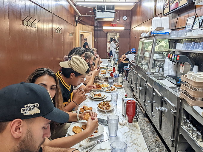 Where strangers become friends. The narrow counter brings people from all walks of life shoulder to shoulder in pursuit of Detroit's favorite comfort food.