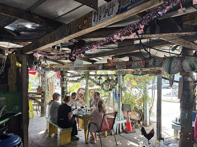 Real people enjoying real food in a place where roosters roam free and nobody's counting calories. This is vacation in sandwich form.