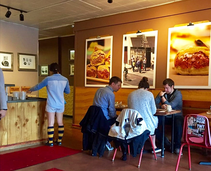 The communal tables foster a sandwich solidarity among strangers united by the universal language of "mmmmm."