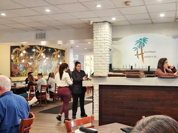 The bustling dining room where memories are made between bites. Notice the vibrant artwork that adds as much flavor to the space as the food.