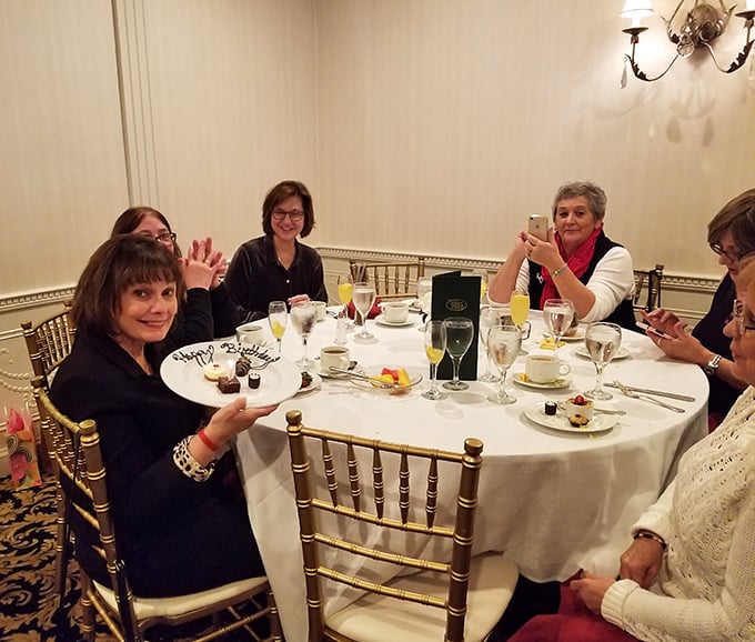 The dining room buzzes with celebration as guests raise glasses around a pristine white tablecloth—where memories are made between courses.