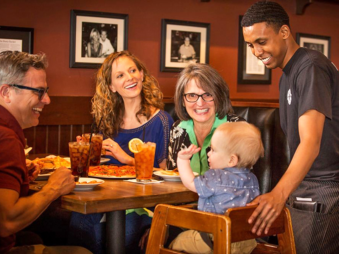 The true measure of a great restaurant: families making memories over shared plates while the server becomes part of the experience.