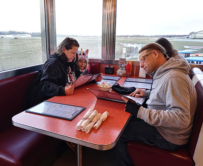Families gather around red tables where memories are made one breakfast at a time.
