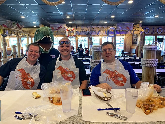 Three generations united by plastic bibs and shared determination to extract every morsel from their crustacean conquest.