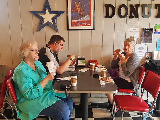 These diners know the secret to happiness: good company, hot coffee, and donuts that make you forget about things like "balanced breakfast" and "moderation."