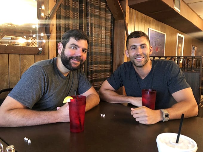 The wooden backdrop frames more than just diners&mdash;it captures the essence of genuine conversation fueled by good food and better company.