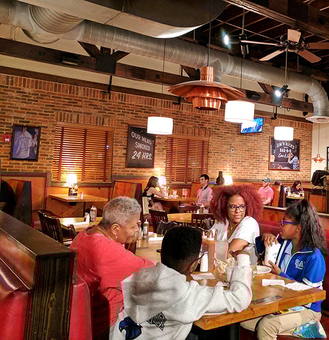 Families gathering around tables at Jim 'N Nick's aren't just eating dinner—they're participating in a time-honored Southern ritual of communion through smoked meat.