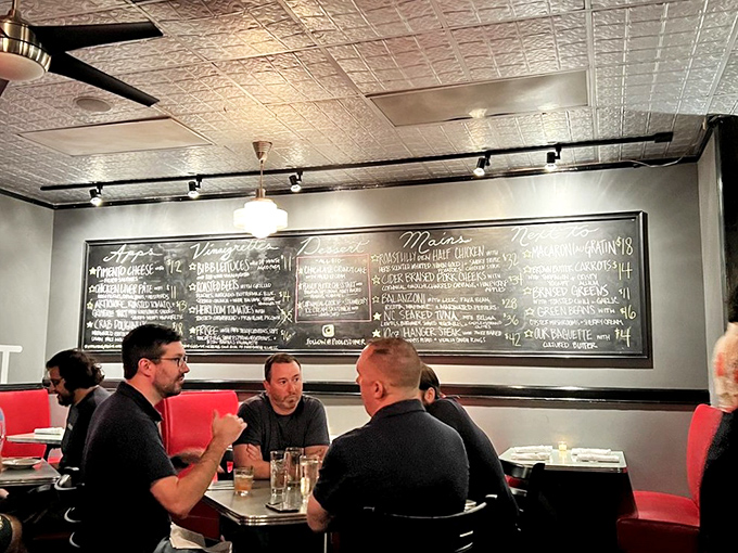 The chalkboard menu tells stories in appetizers and entr&eacute;es while diners plot their culinary adventure in hushed, excited tones.