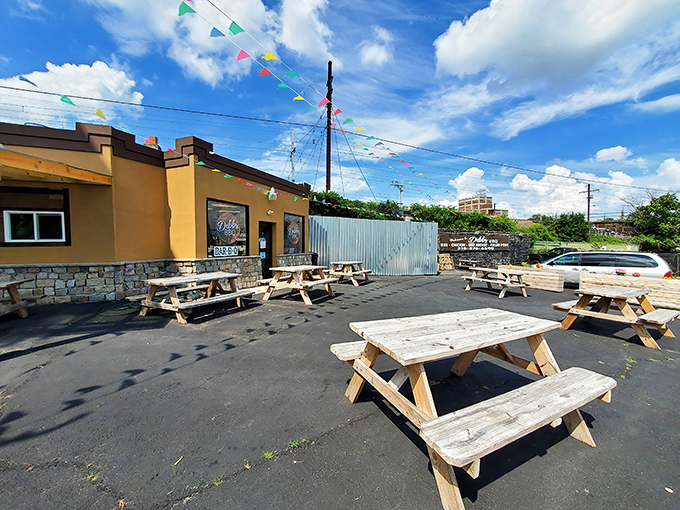 The outdoor dining area under blue Pennsylvania skies, where wooden picnic tables await the parade of smoky delights from inside.