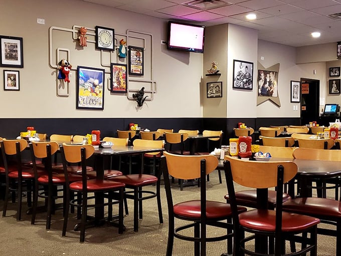 Empty tables that won't stay that way for long. The wall art collection looks like it was curated by someone's cool grandparents &ndash; eclectic and endearing.