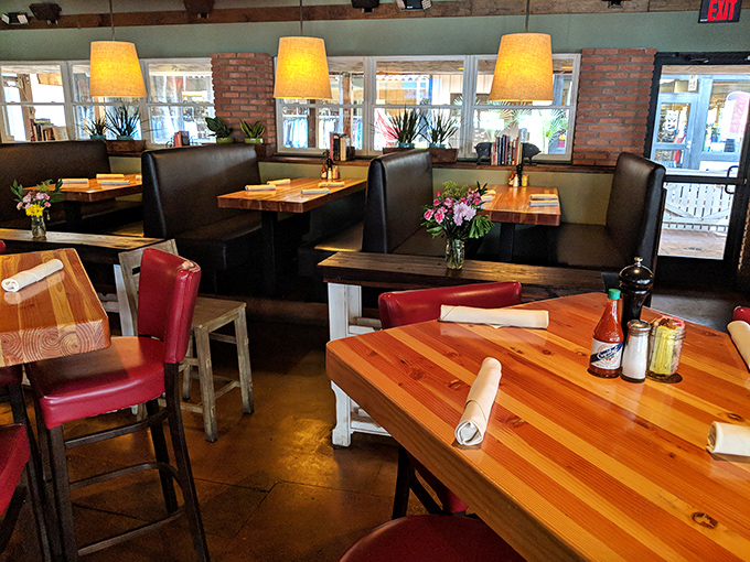 Warm wood tones, leather booths, and golden lighting create the perfect backdrop for both first dates and family gatherings.