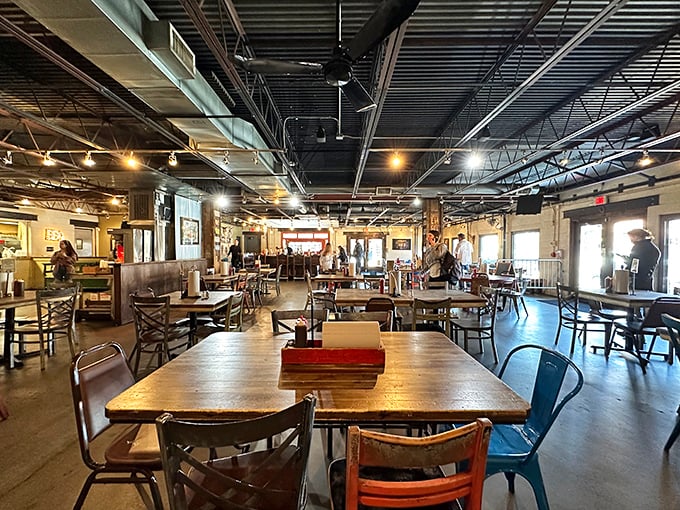 The industrial ceiling and mismatched chairs create a no-nonsense atmosphere where the food, not the decor, rightfully takes center stage.