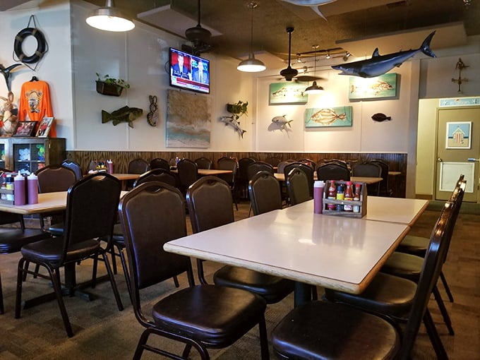 The dining room balances casual comfort with coastal charm. Those mounted fish on the wall? They're keeping an eye on your table manners.