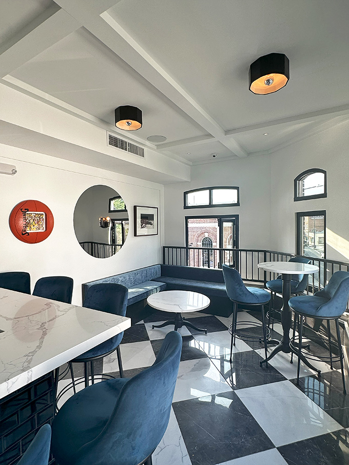Blue velvet seating against marble and checkerboard floors&mdash;this dining space feels like the sophisticated living room you've always wanted.