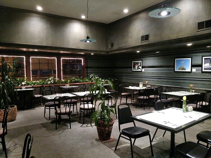 Potted plants and thoughtful lighting transform this dining room into a cozy retreat where breakfast dreams come true.