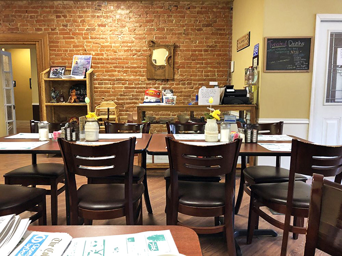 Simple wooden chairs and tables bathed in natural light create the perfect backdrop for conversations that flow as easily as the coffee.