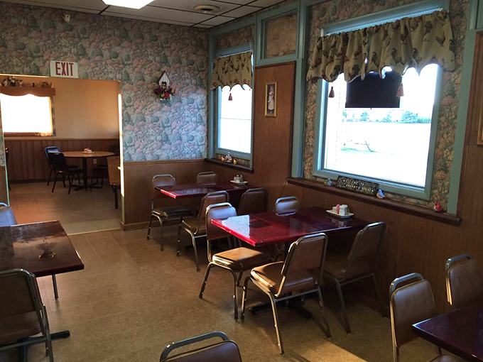 Floral wallpaper and wood paneling create that classic small-town restaurant vibe. Where conversations flow as easily as the coffee refills.