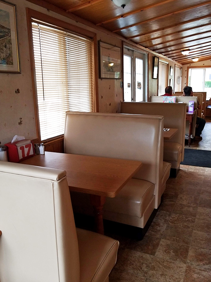 Cream-colored booths line the walls like old friends waiting for a chat, beneath wooden ceilings that have witnessed countless celebrations.