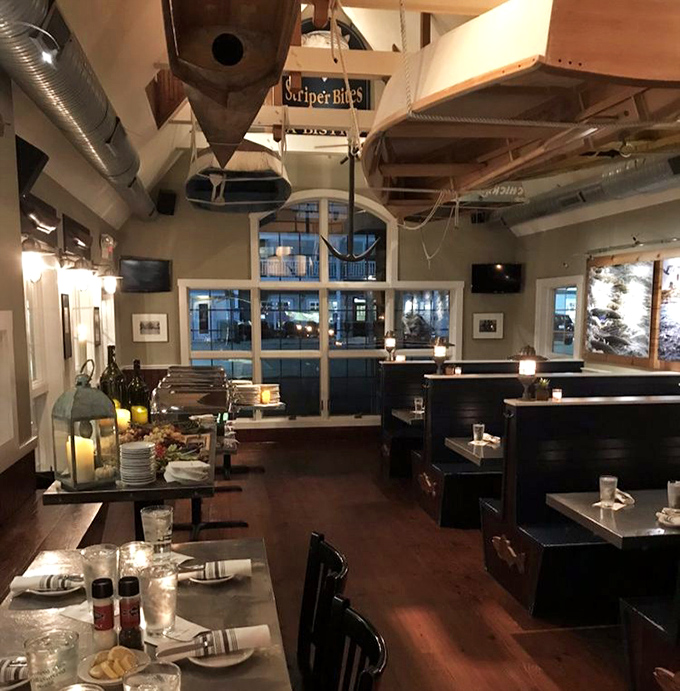 Evening transforms the dining room into a maritime sanctuary where conversations flow as smoothly as the local brews.