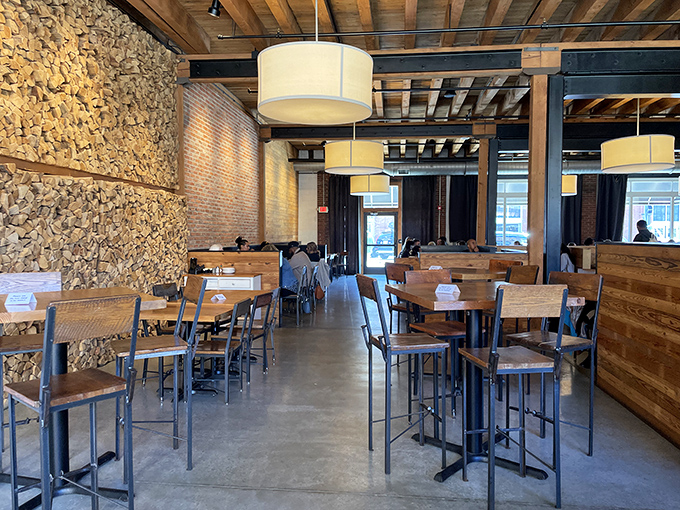 Stone walls meet reclaimed wood in this dining area where industrial elements and natural materials create a space that feels both timeless and thoroughly contemporary.